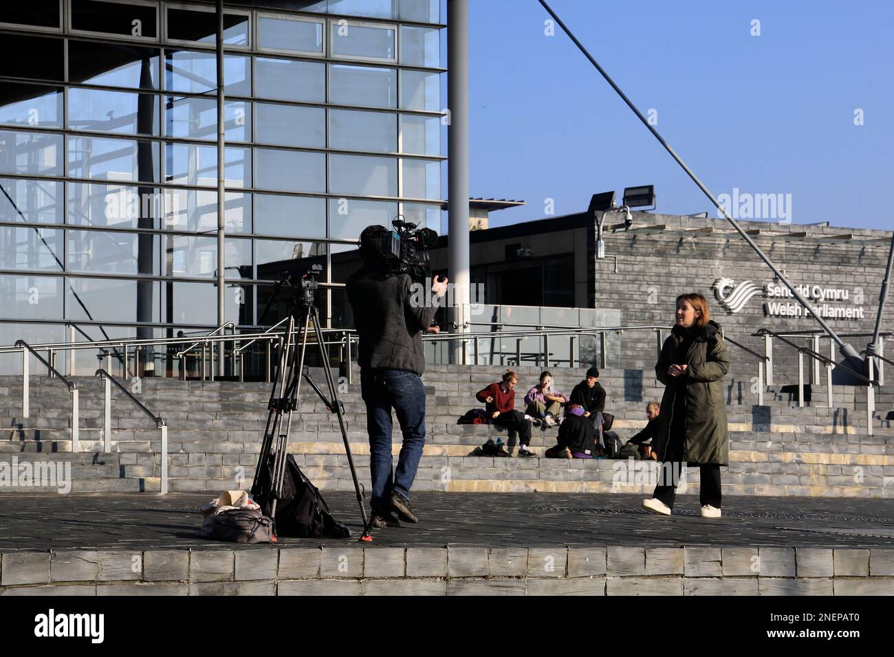 Filming a piece-to-camera outside the Senedd building, Cardiff Bay ...