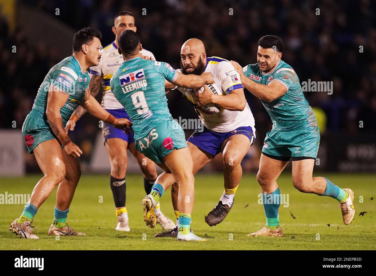 Warrington Wolves' Sam Kasiano (centre) is tackled by Leeds Rhinos ...