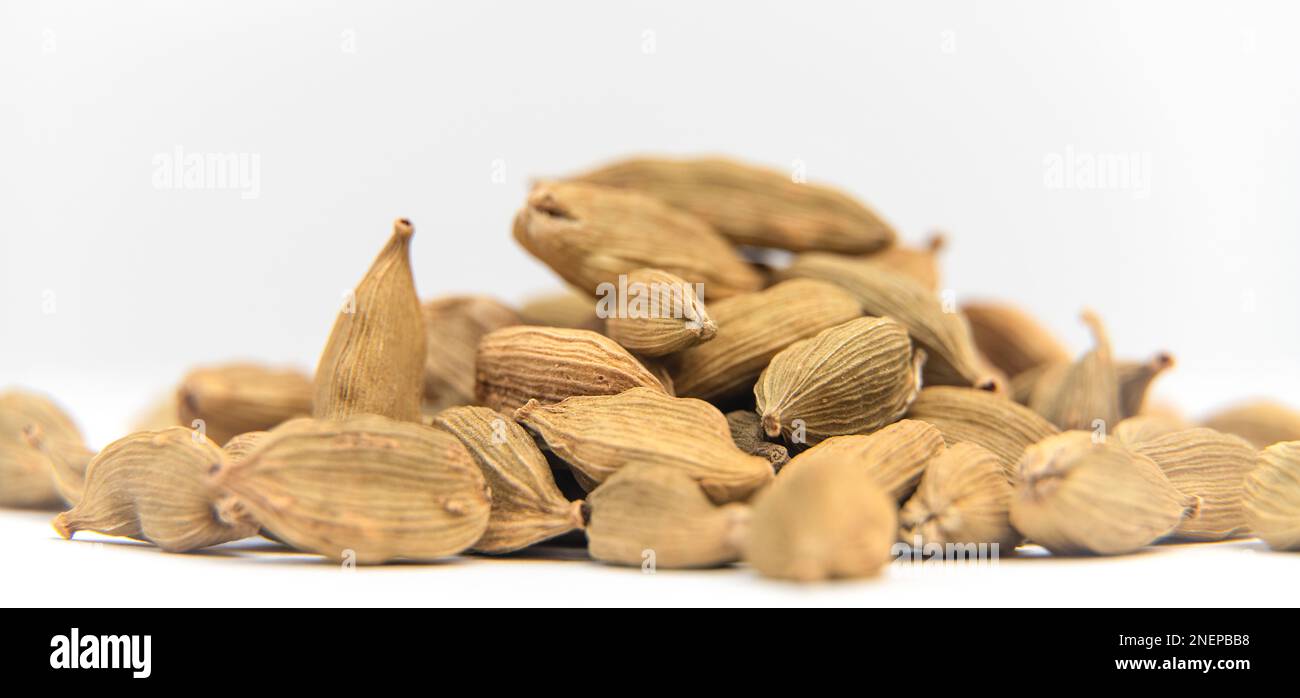Cardamon seeds on a white background Stock Photo - Alamy