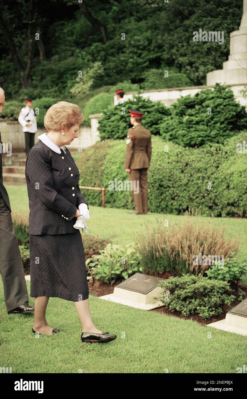 British Prime Minister Margaret Thatcher, in subdued dark blue suit ...