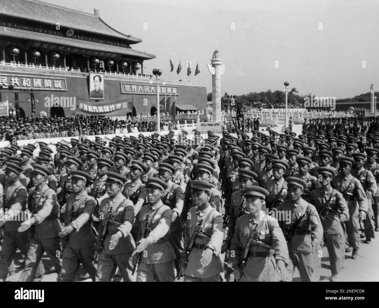 Units of the Army of Liberation march past the reviewing stand, which ...
