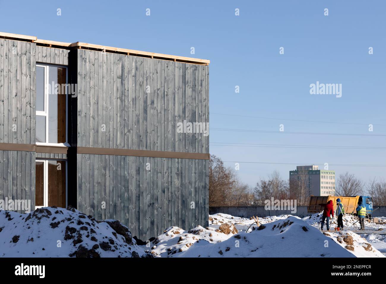 Wooden facade of a detached modular house with windows on the ...