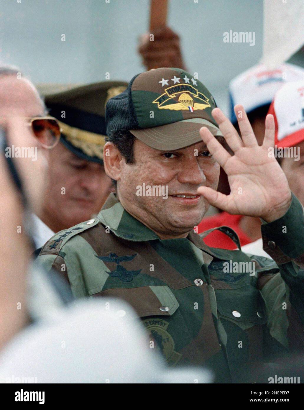 General Manuel Noriega waves to journalists, May 2, 1989 at a housing ...