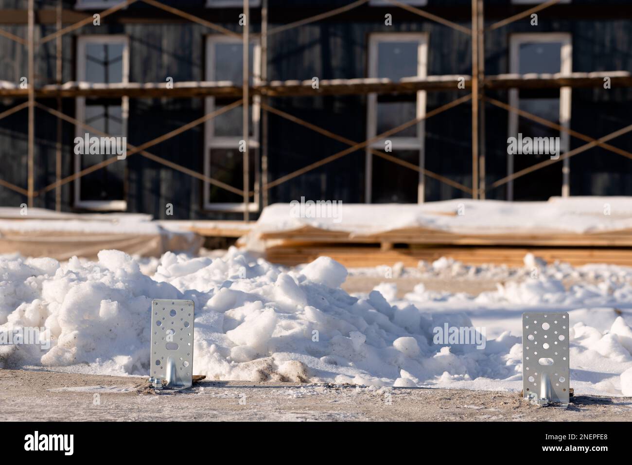 Close-up of metal fasteners in the foundation of a modular home against ...
