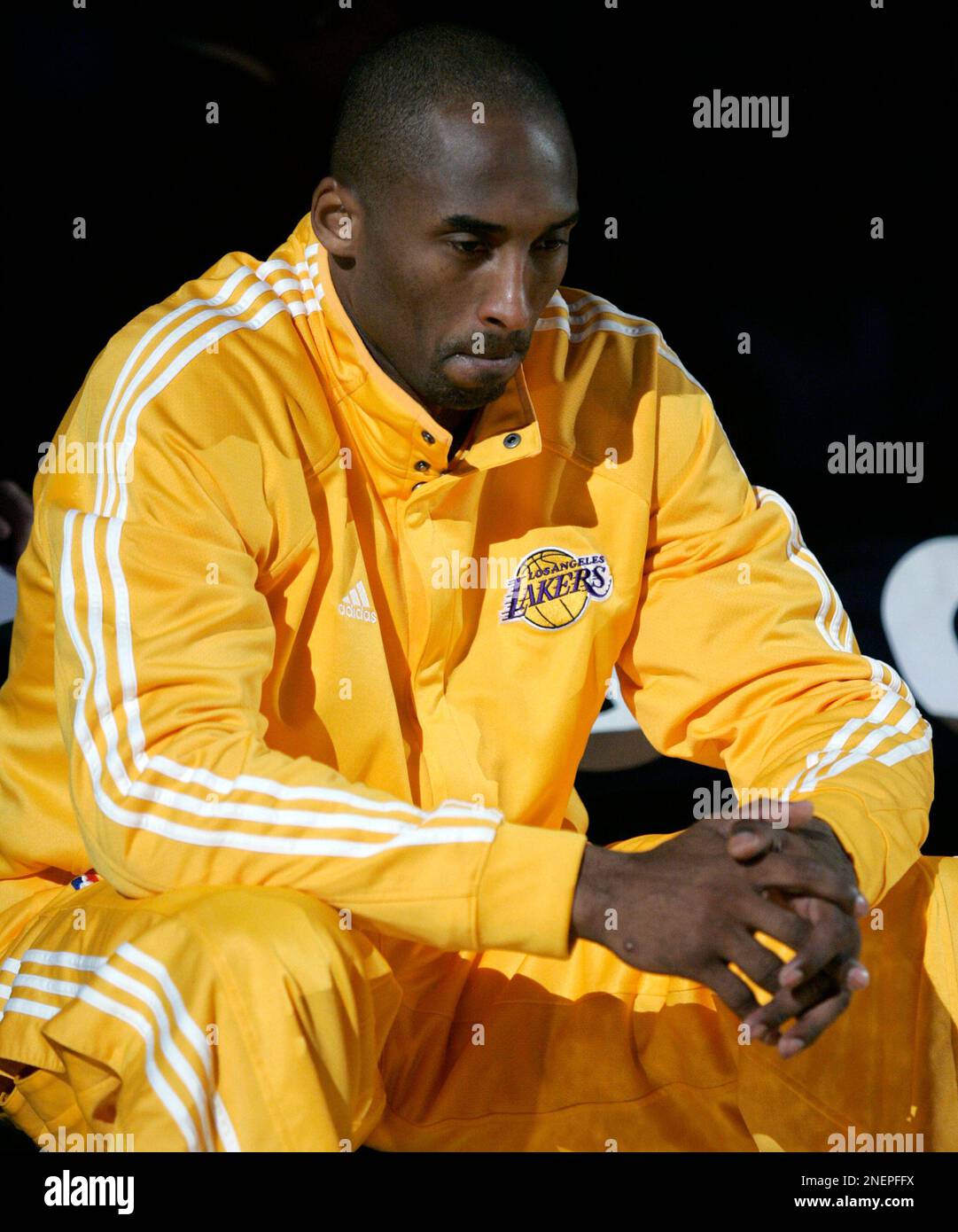 Los Angeles Laker Kobe Bryant sits on the bench before the game against ...