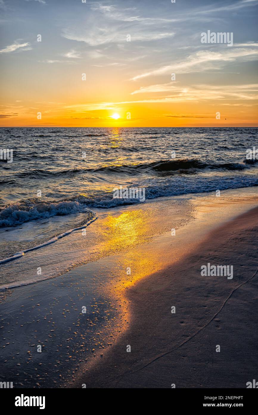 Colorful vertical sunset seascape and sun horizon in Gulf of Mexico sea ...