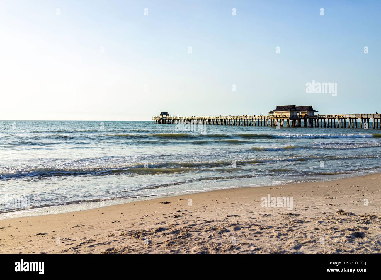 Naples, Florida famous pier at sunset in gulf of Mexico coast as wooden ...