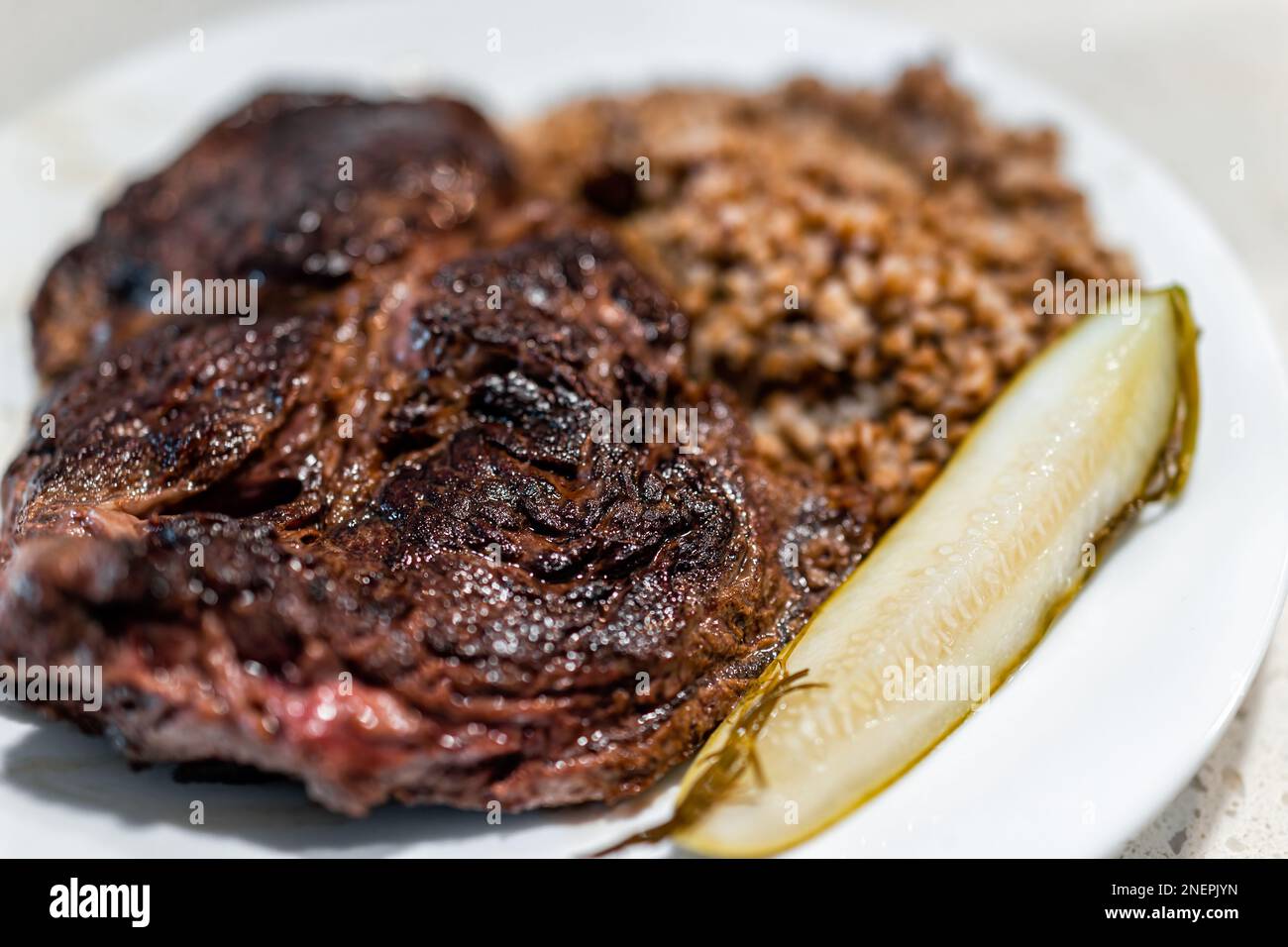 Cooked ribeye steak macro closeup with thick cut and brown crust on ...