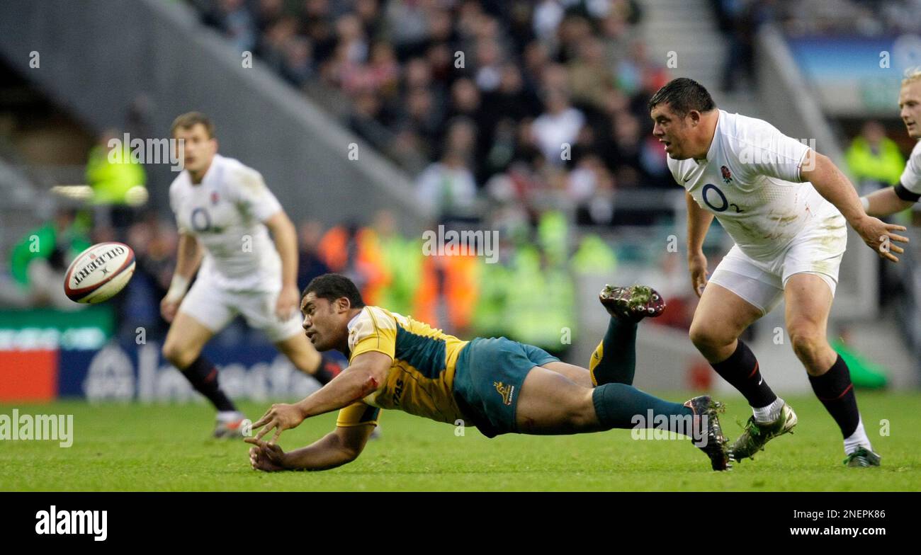 England 's Duncan Bell, right, looks on as Australia's Will Genia gets ...