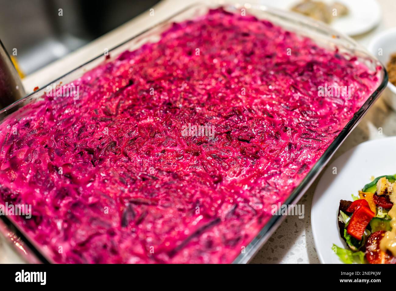 Dinner meal preparation or serving of Russian beet salad vegetable dish ...