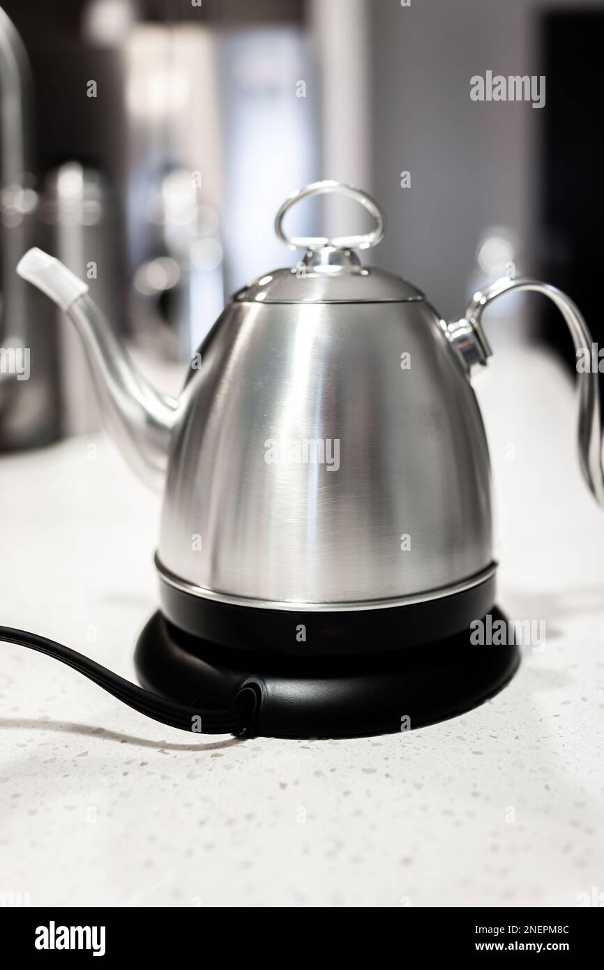 Tea kettle brand new electric appliance closeup with cord and modern ...