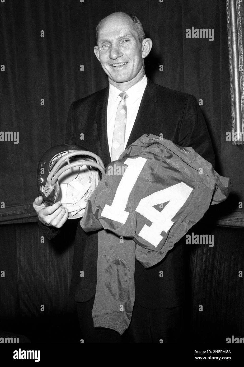 New York Giants quarterback Y.A. Tittle poses with his jersey and ...