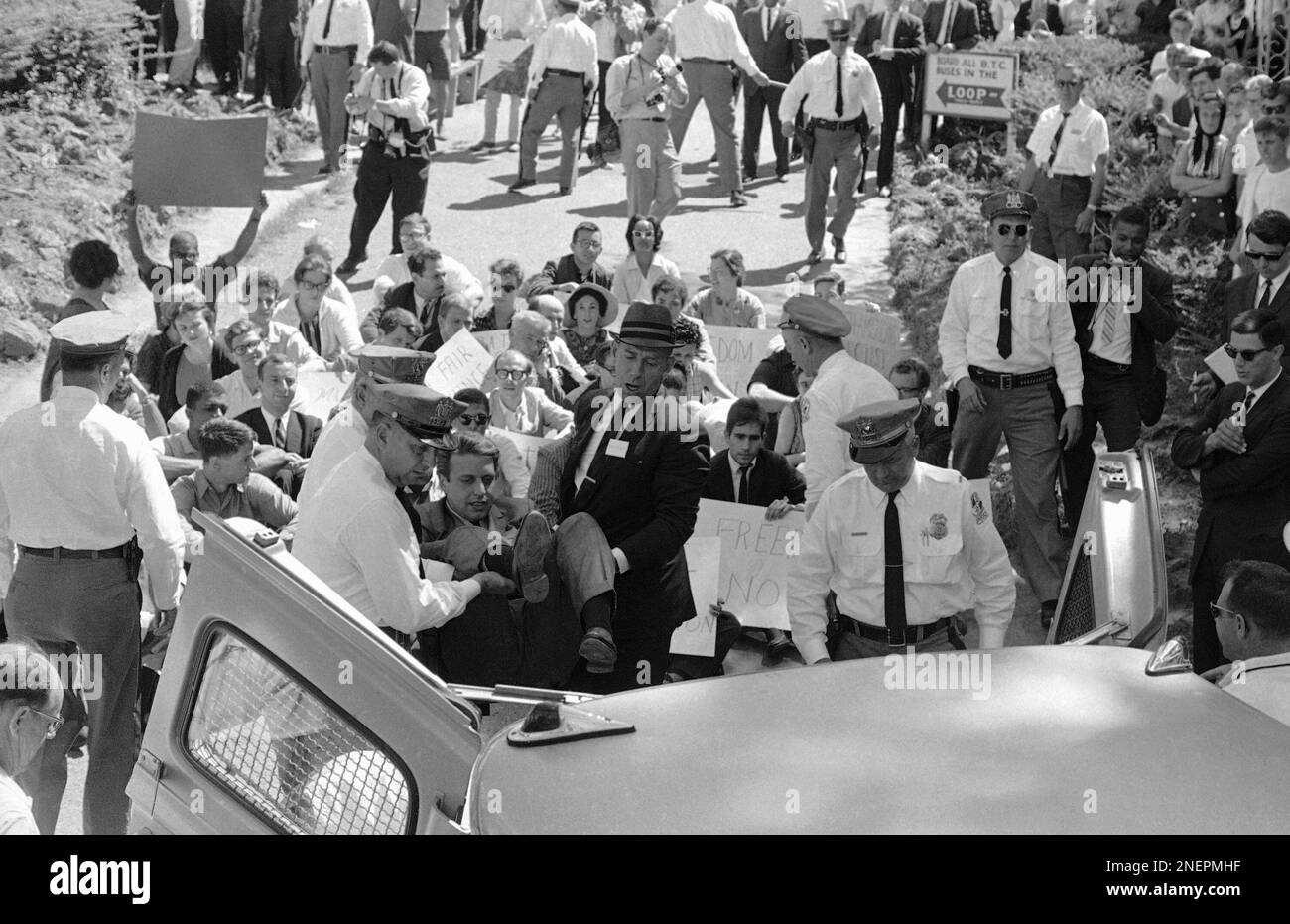 Baltimore County police officers lift a white demonstrator into a ...