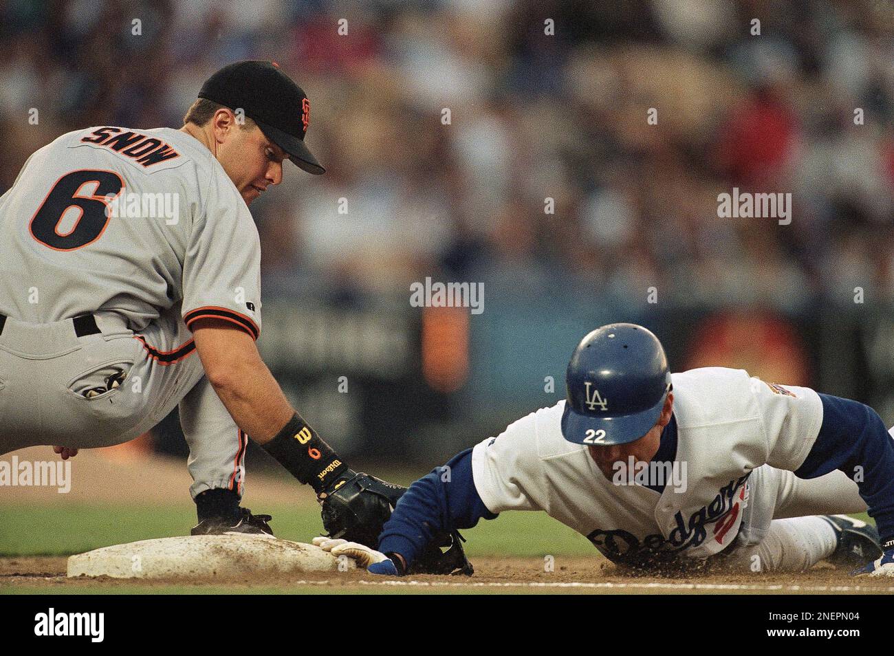 Brett Butler of the Los Angeles Dodgers dives under the tag of J.T ...