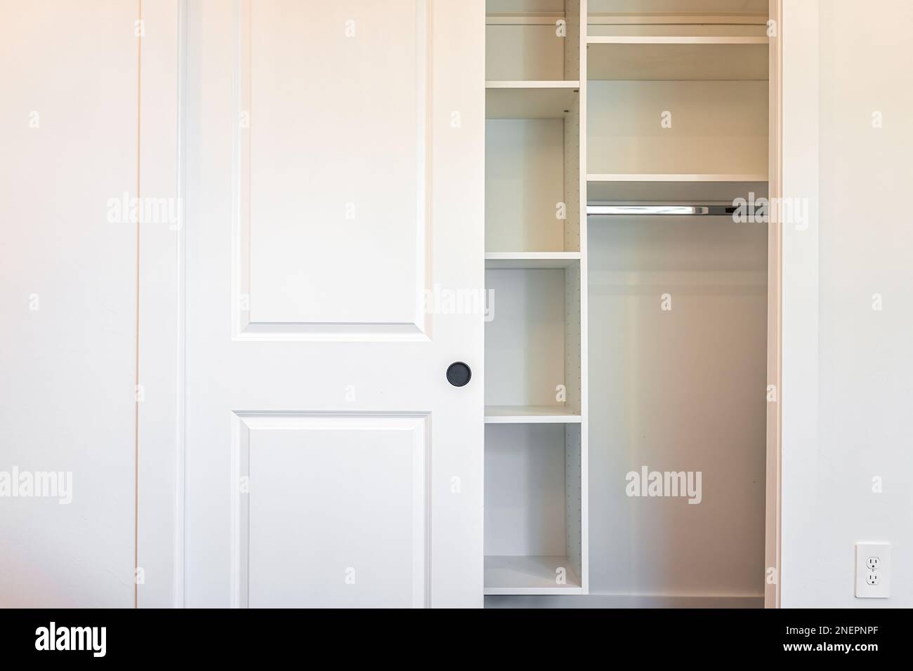 Walk-in closet shelves with sliding door in modern minimalist white ...