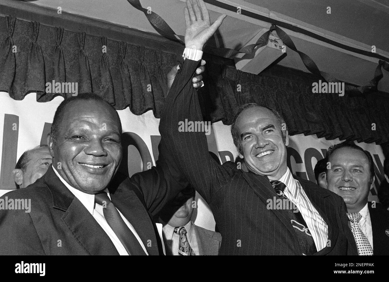 Former Heavyweight Champion Jersey Joe Walcott holds aloft, in the ...