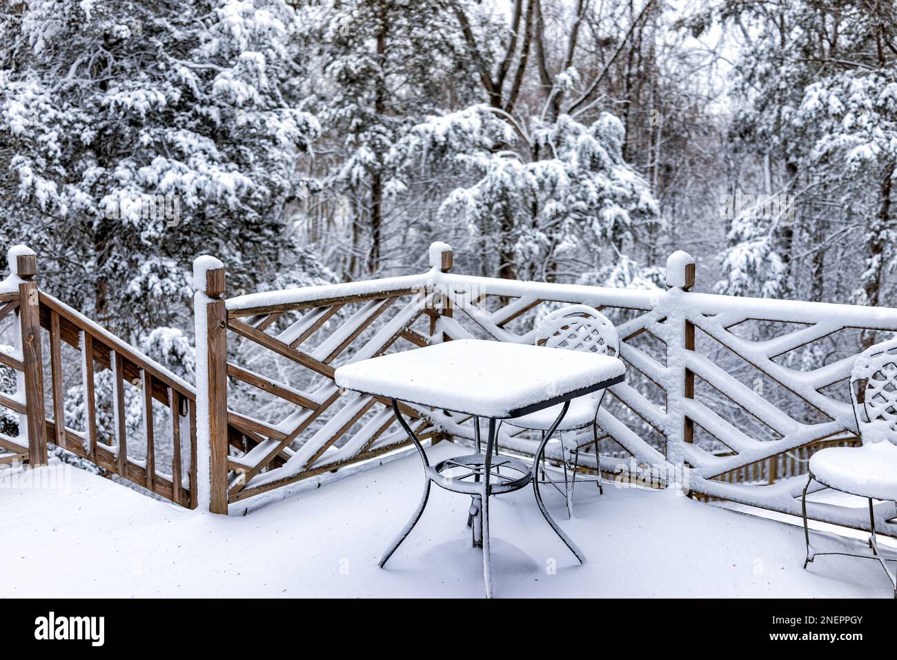 Metal outdoor table and chairs covered in white snow on home house ...