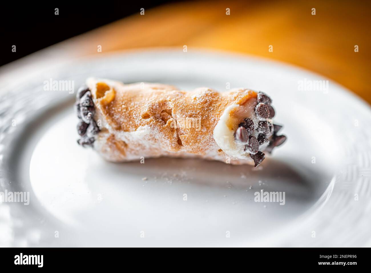 Italian cannolo pastry dessert closeup on white plate macro with ...