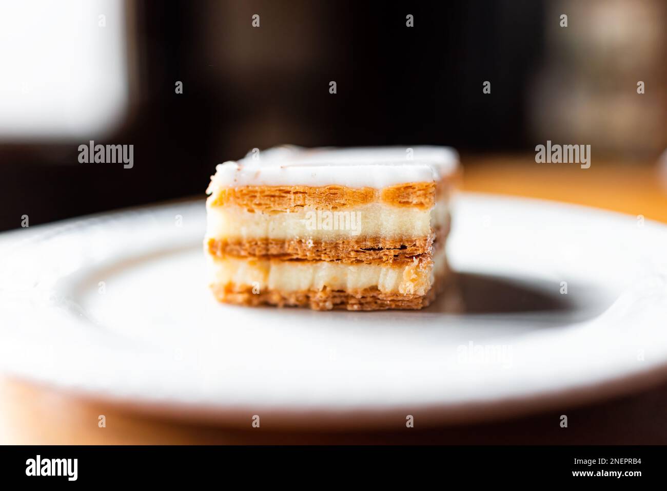 French Napolean cake slice closeup on white plate side view macro with ...