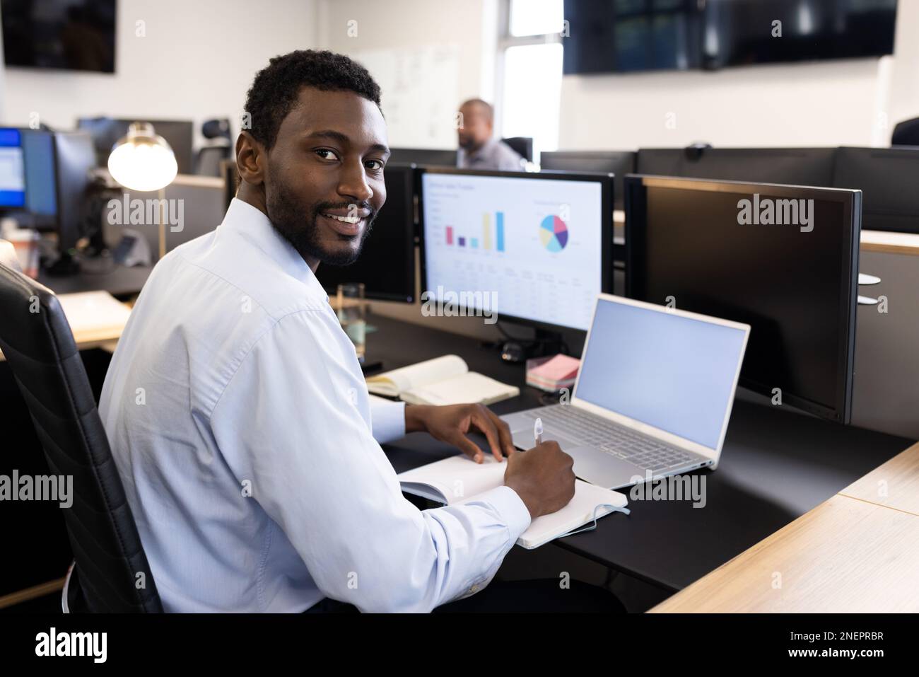Happy african american man working on laptop in office Stock Photo - Alamy