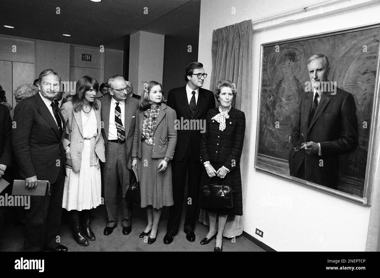 Members of the Rockefeller family gather beside a portrait of John D ...