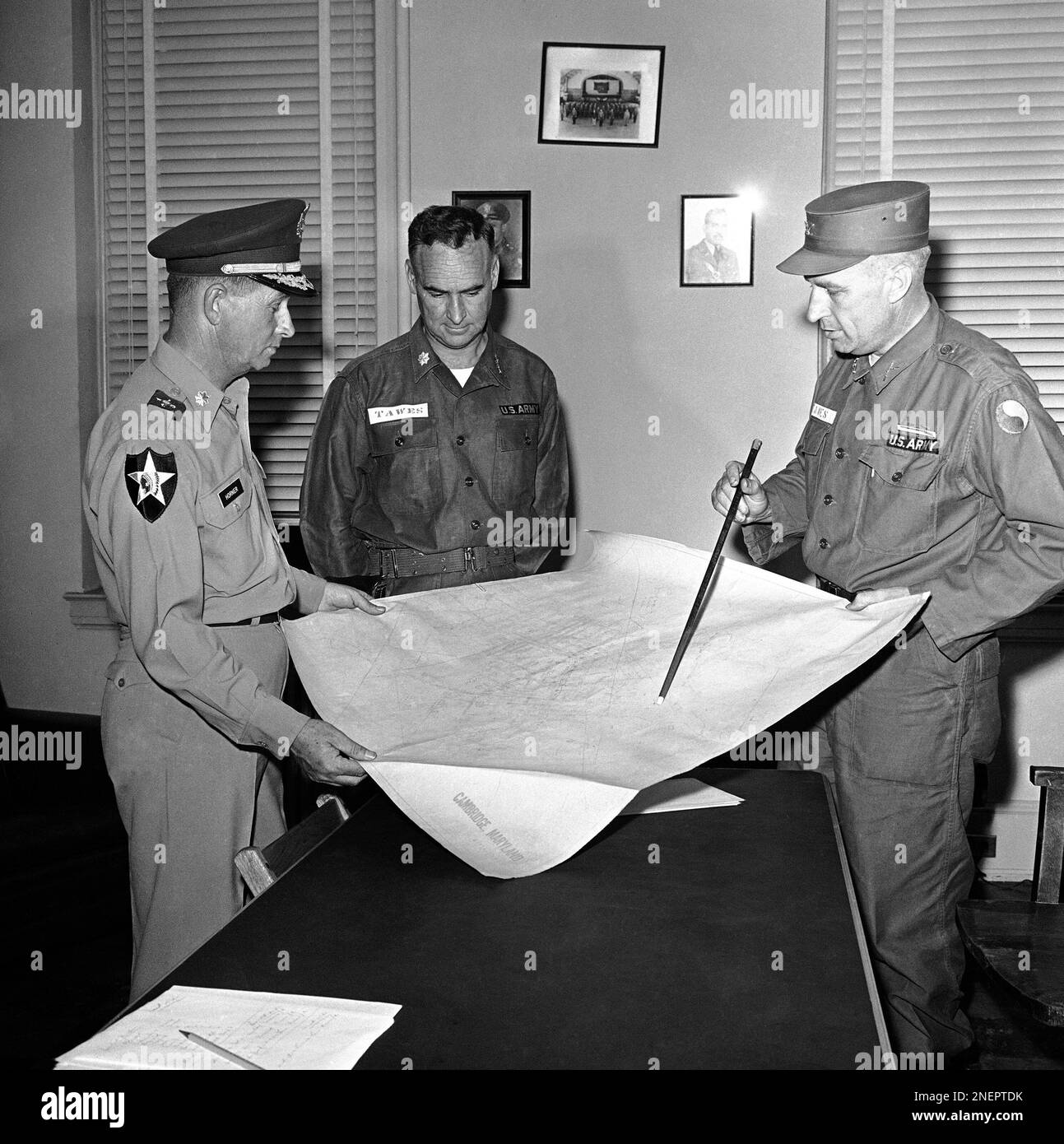 National Guard officers go over a map of the city after the local guard ...