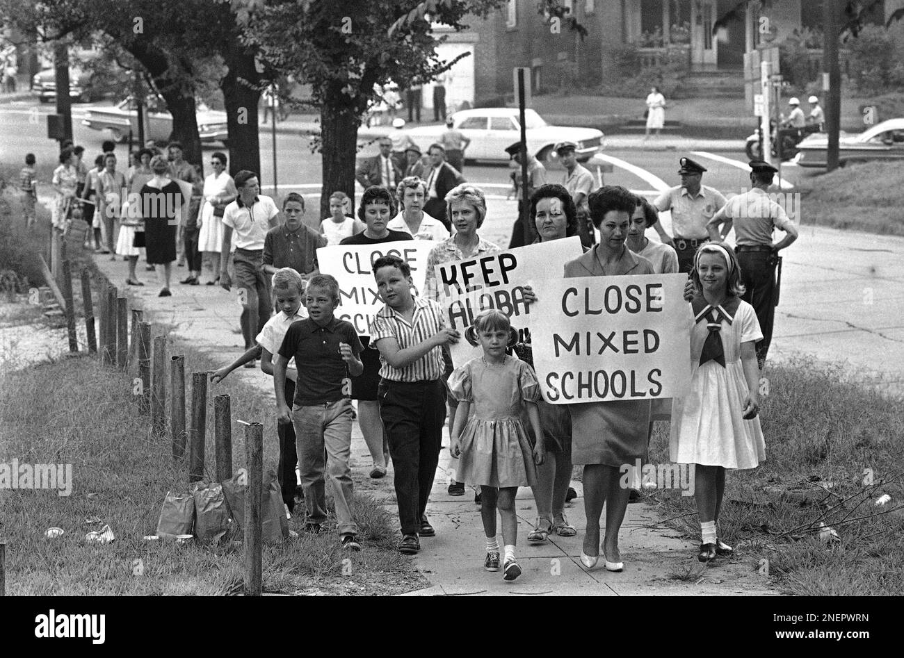 Mothers carrying protest signs accompany their children to Graymont ...