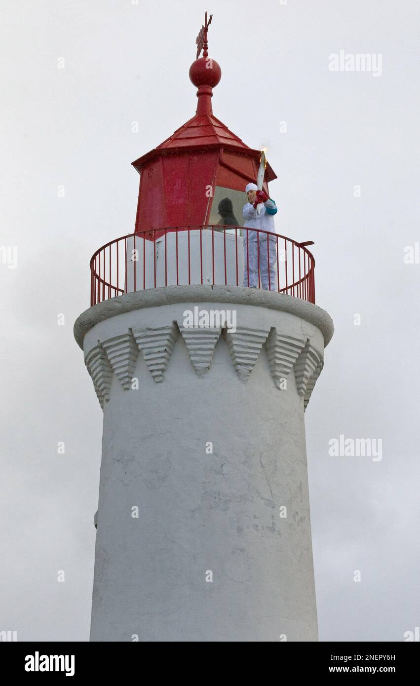 Laura Mongeau carries the Olympic flame at the top of Fisgard ...