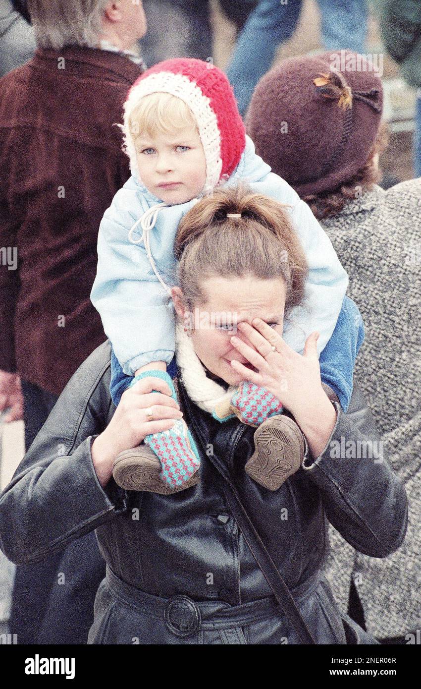 An East German mother is overwhelmed by emotion as she crosses the ...