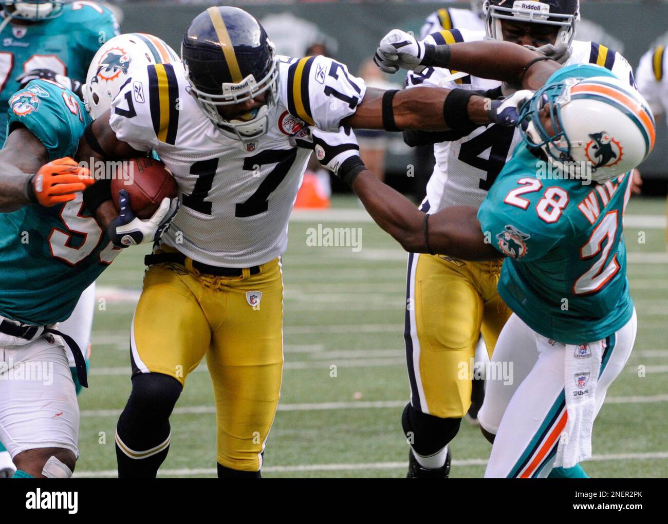 New York Jets wide receiver Braylon Edwards (17) stiff-arms Miami ...