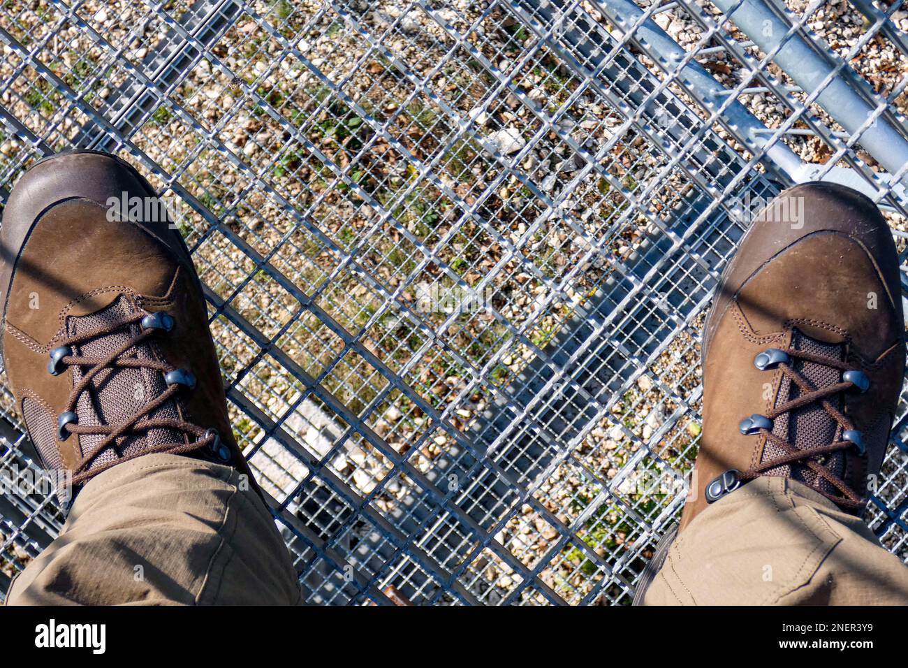 Hiking boot legs photographed on top of a lookout from above Stock ...