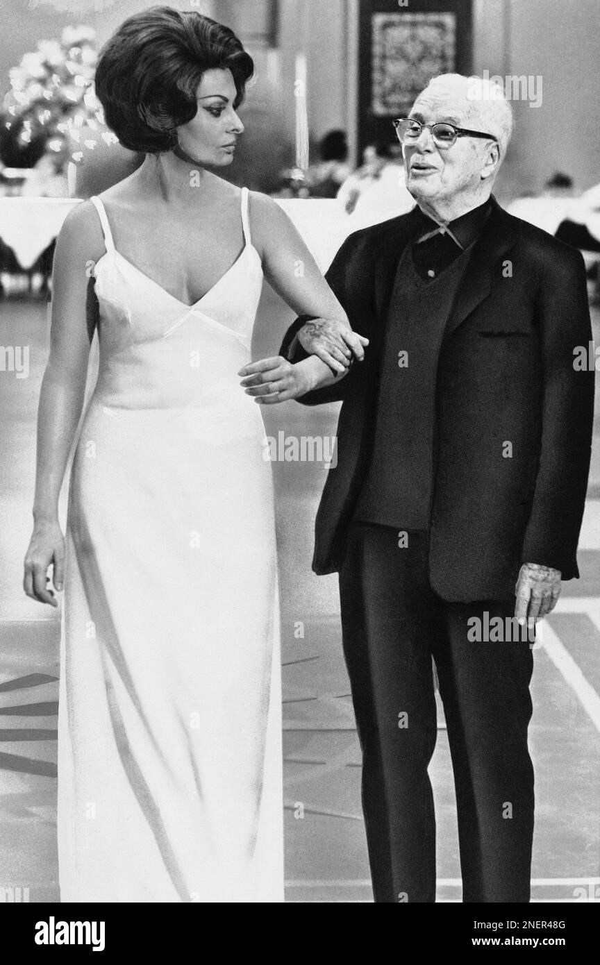 Charles Chaplin shows his leading lady, Sophia Loren, how he wants her ...