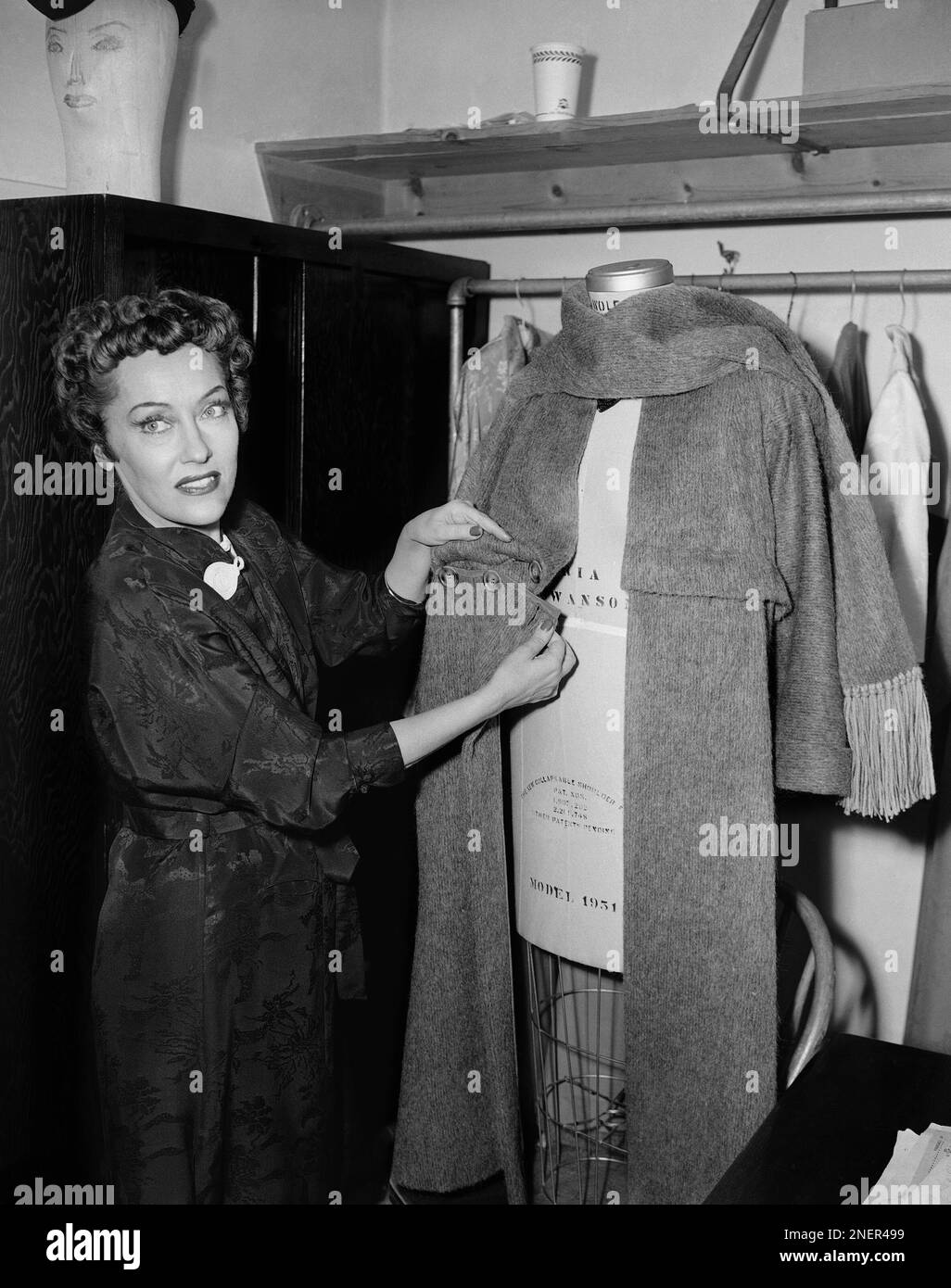 Gloria Swanson shows how her two-way coat works on Sept. 26, 1951. The ...