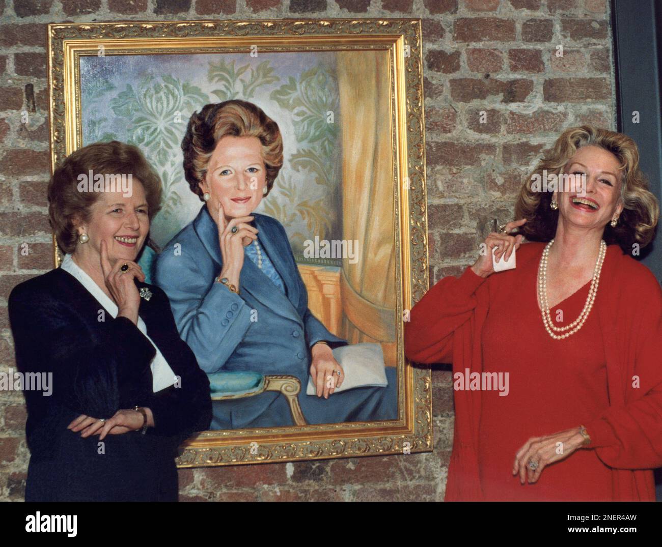 British Prime Minister Margaret Thatcher receives a portrait painted ...