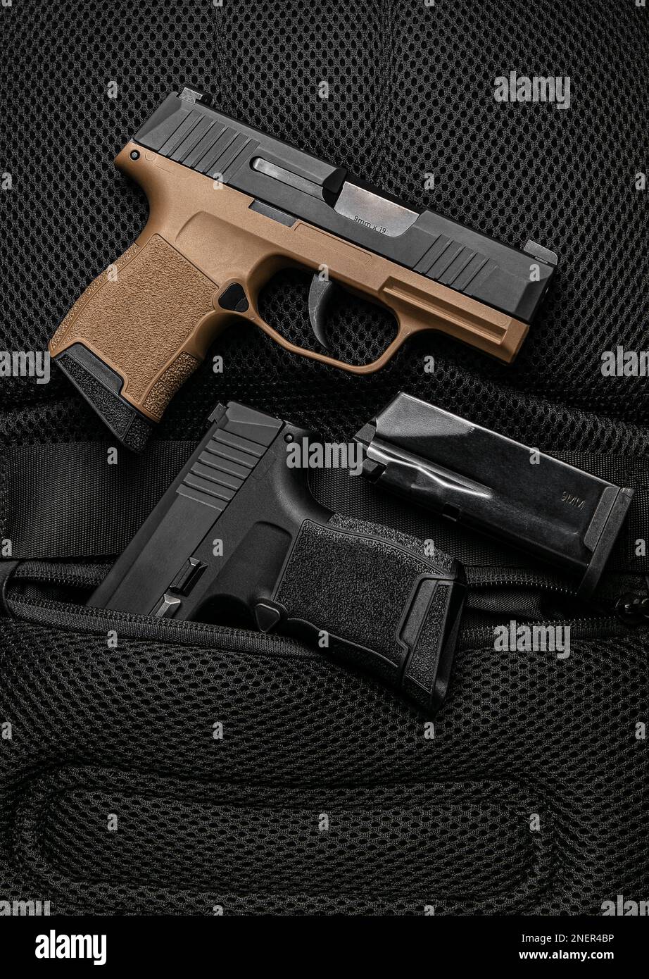 A small modern brown semi-automatic pistols. A short-barreled weapon ...