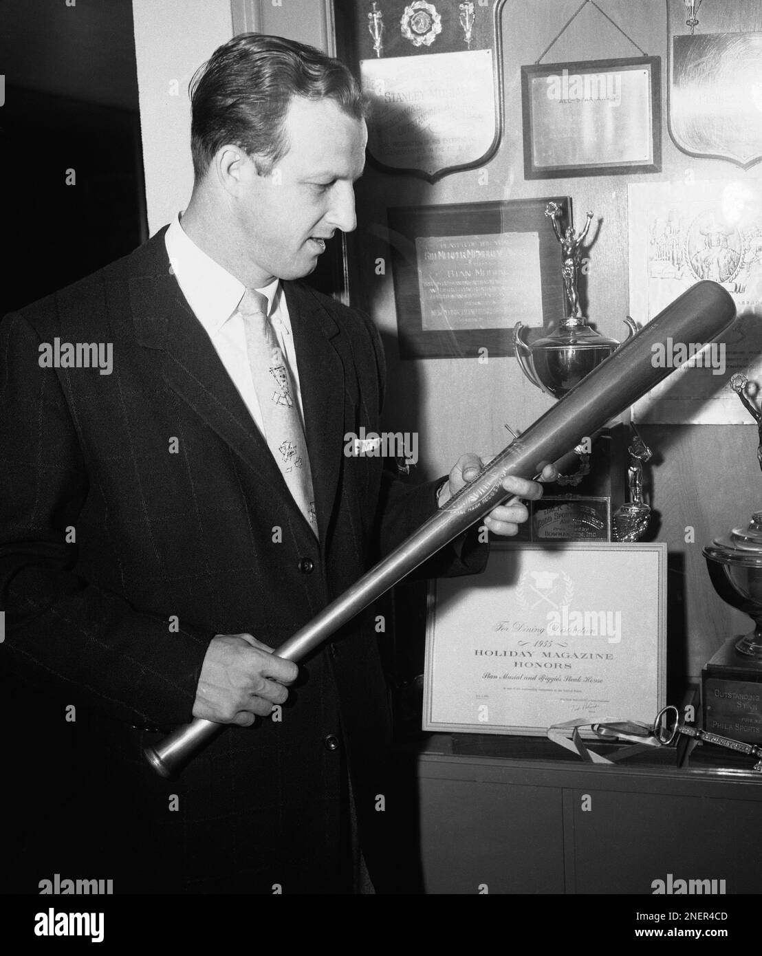 Stan Musial, Cardinal outfielder, stands in front of his display of ...
