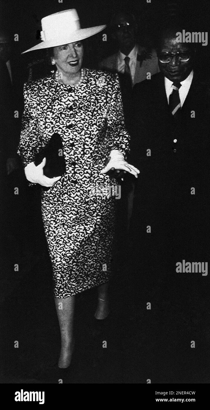 British Prime Minister Margaret Thatcher holds the hand of President ...