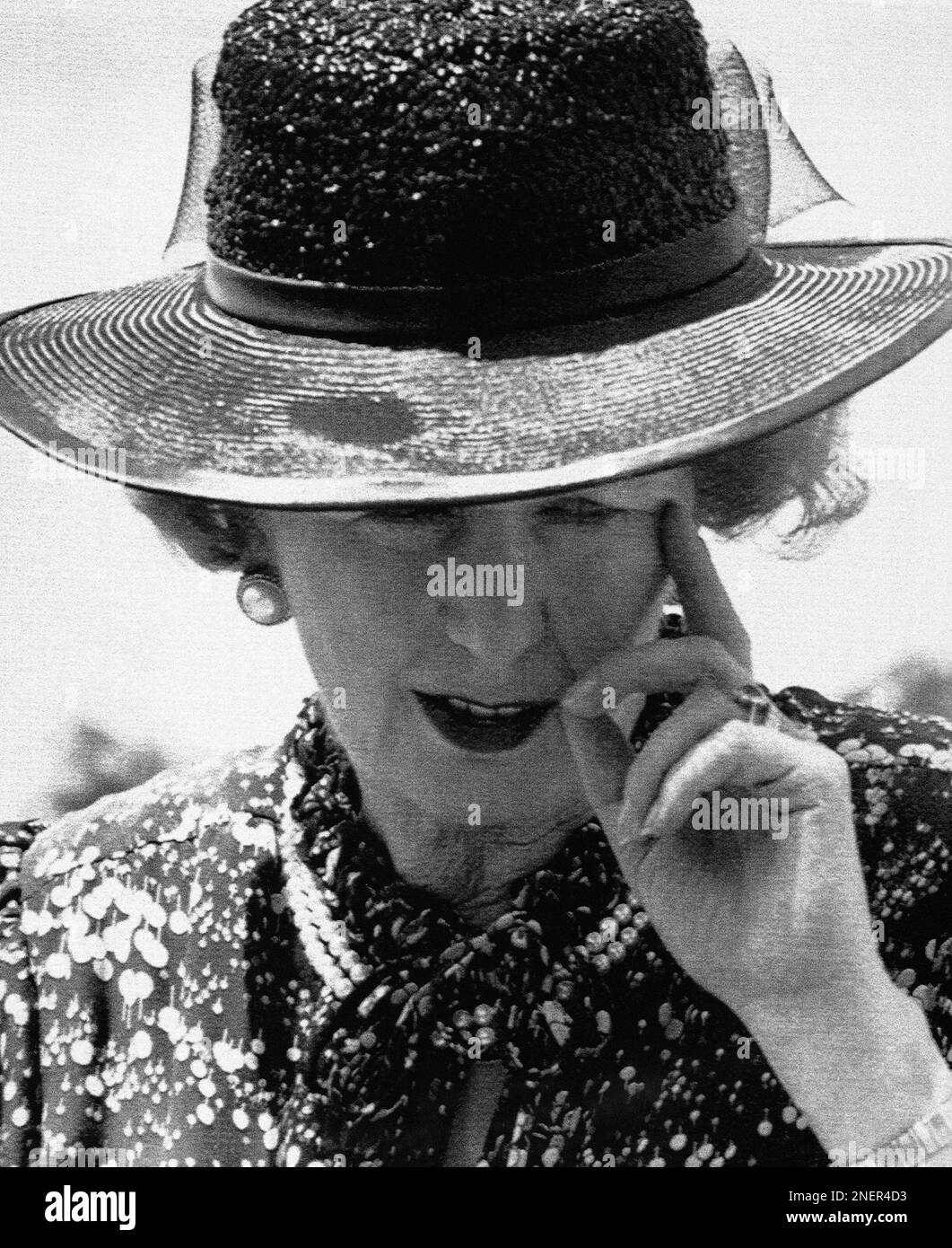 British Prime Minister Margaret Thatcher wipes a tear as she walks past ...