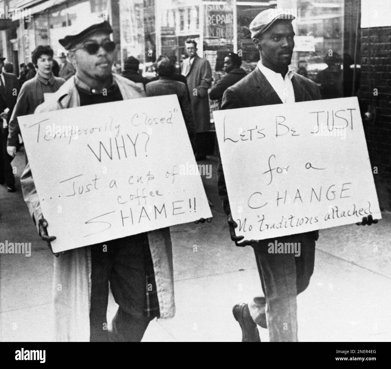 Walking holding placard western script protest Black and White Stock ...