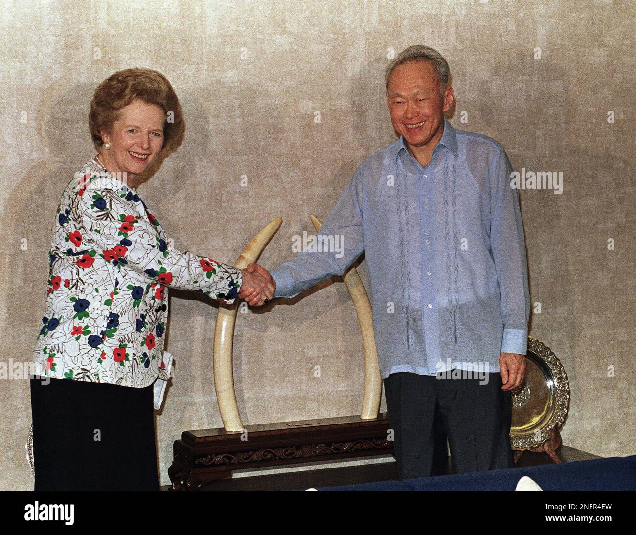 British Prime Minister Margaret Thatcher shakes hands with Singapore ...