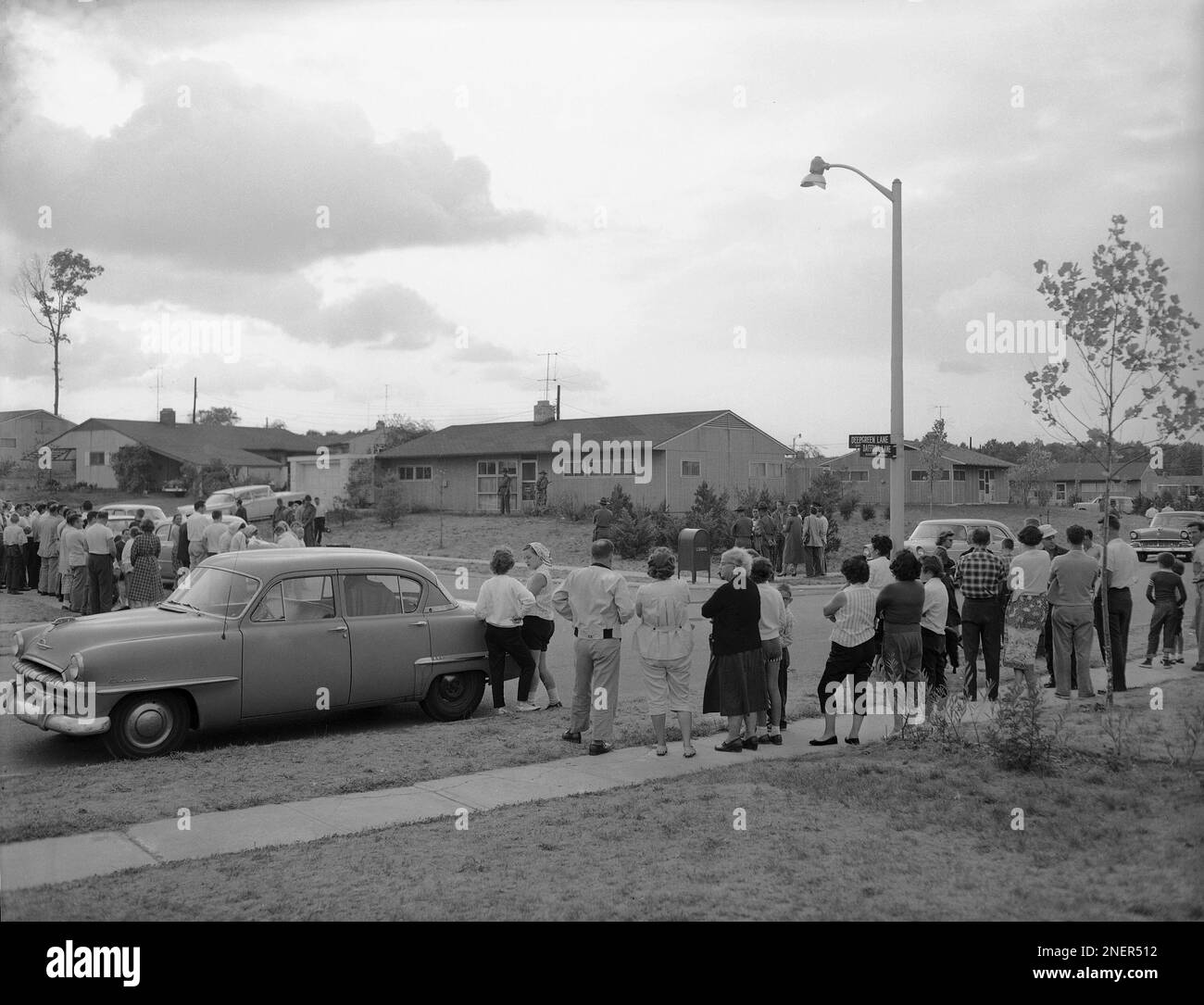 A crowd gathers in front of the home of Mr. and Mrs. William Myers ...