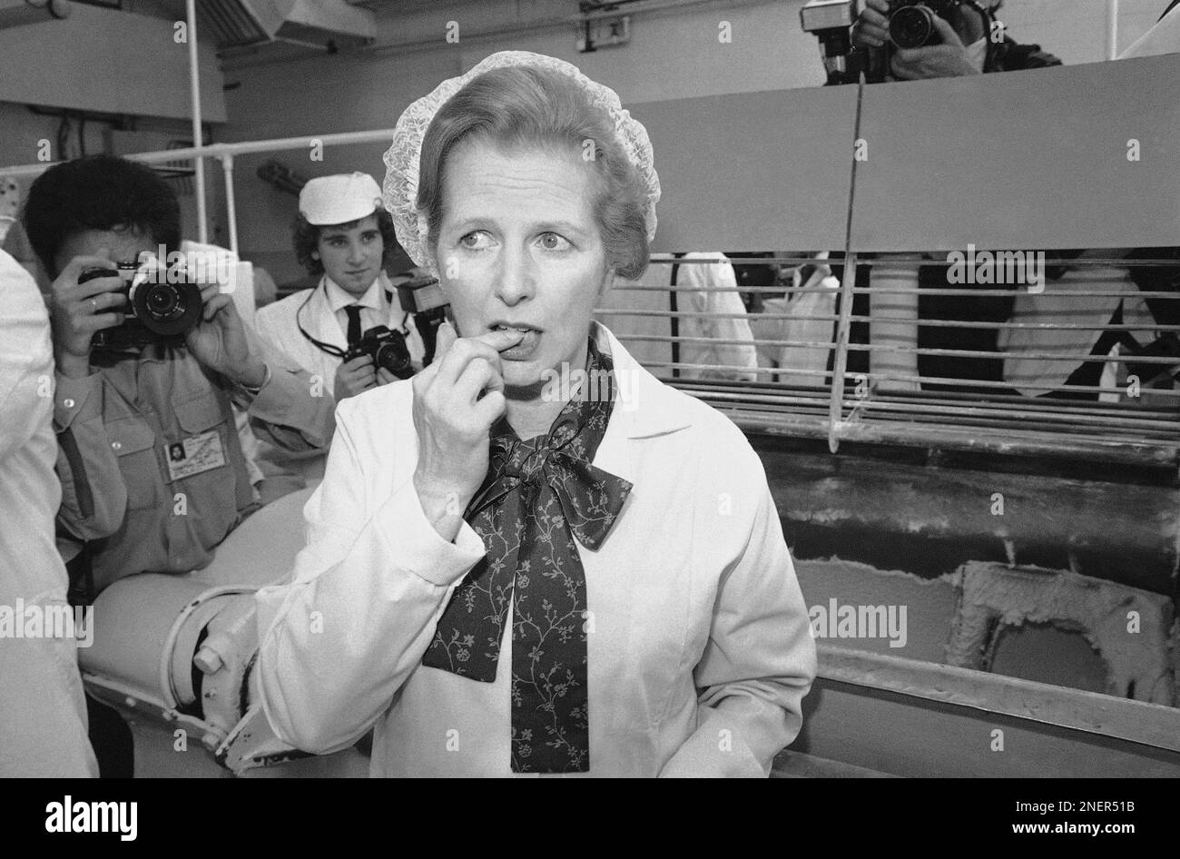 Britain?s Prime Minister Margaret Thatcher slowly eats a sample during ...