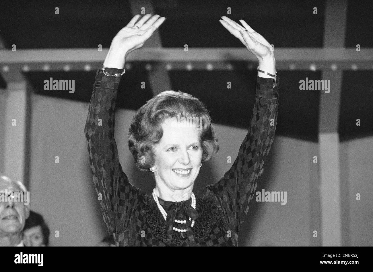 Britain?s Prime Minister Margaret Thatcher raises her arms in ...