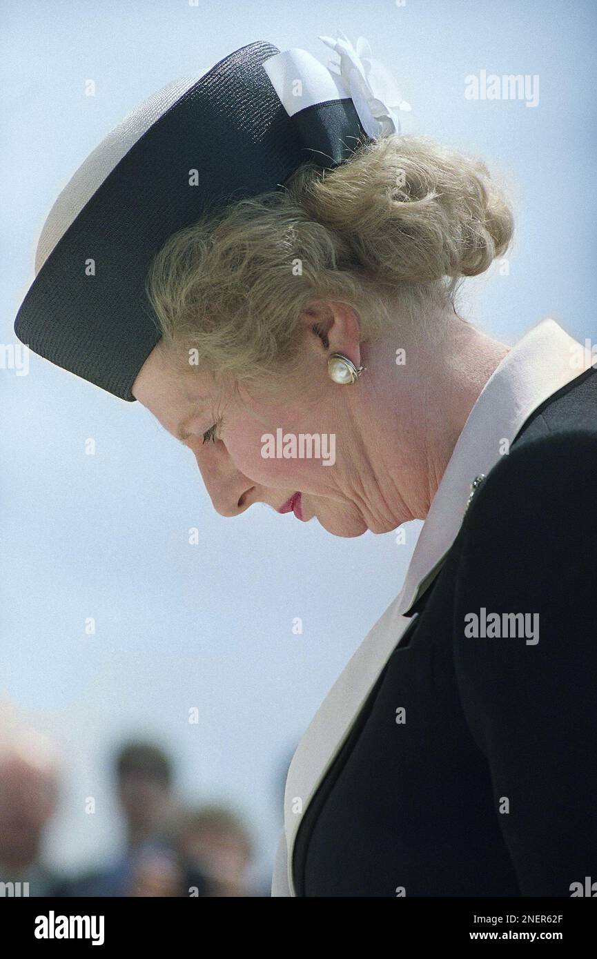 British Premier Margaret Thatcher bows her head in silent prayer after ...