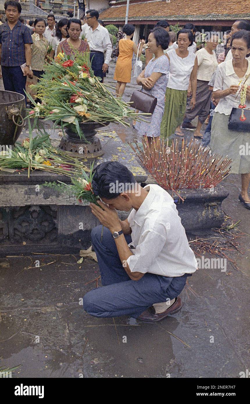A man prays outside the Marble Temple in Bangkok, Thailand, Sept. 1969 ...