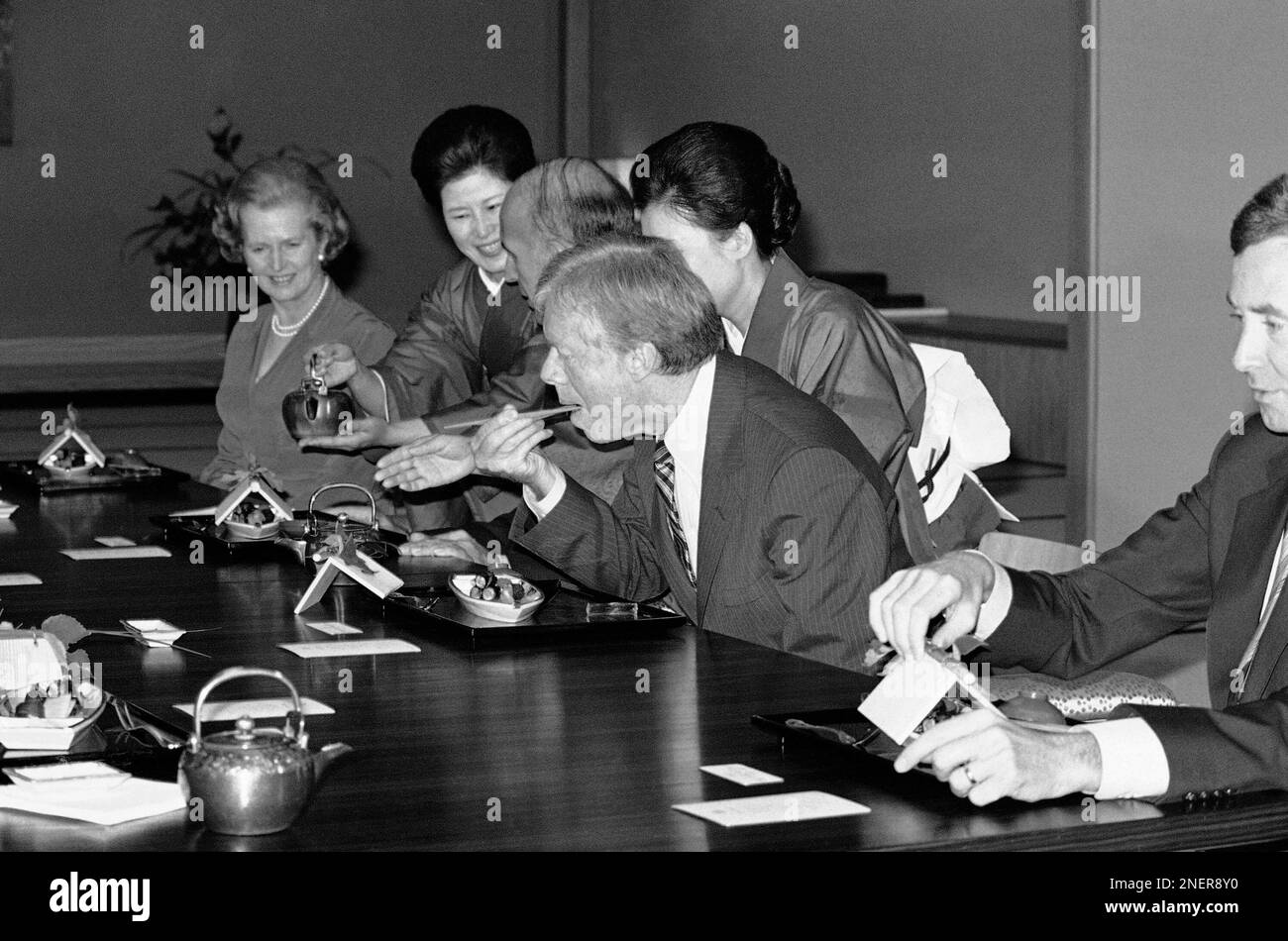 President Jimmy Carter tries his hand with chopsticks as British Prime ...