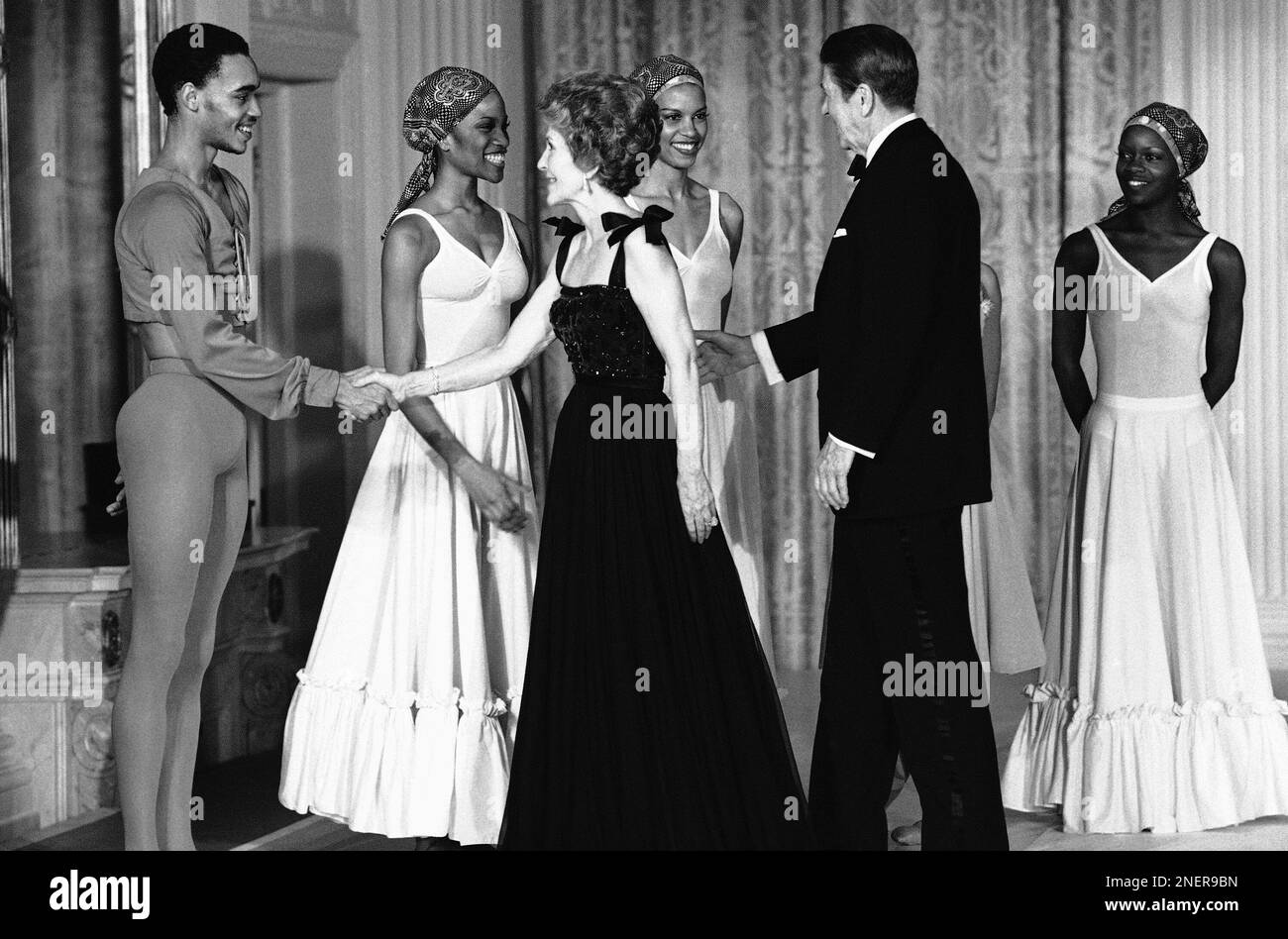 President Roland Reagan and his wife Nancy shake hands with members of ...