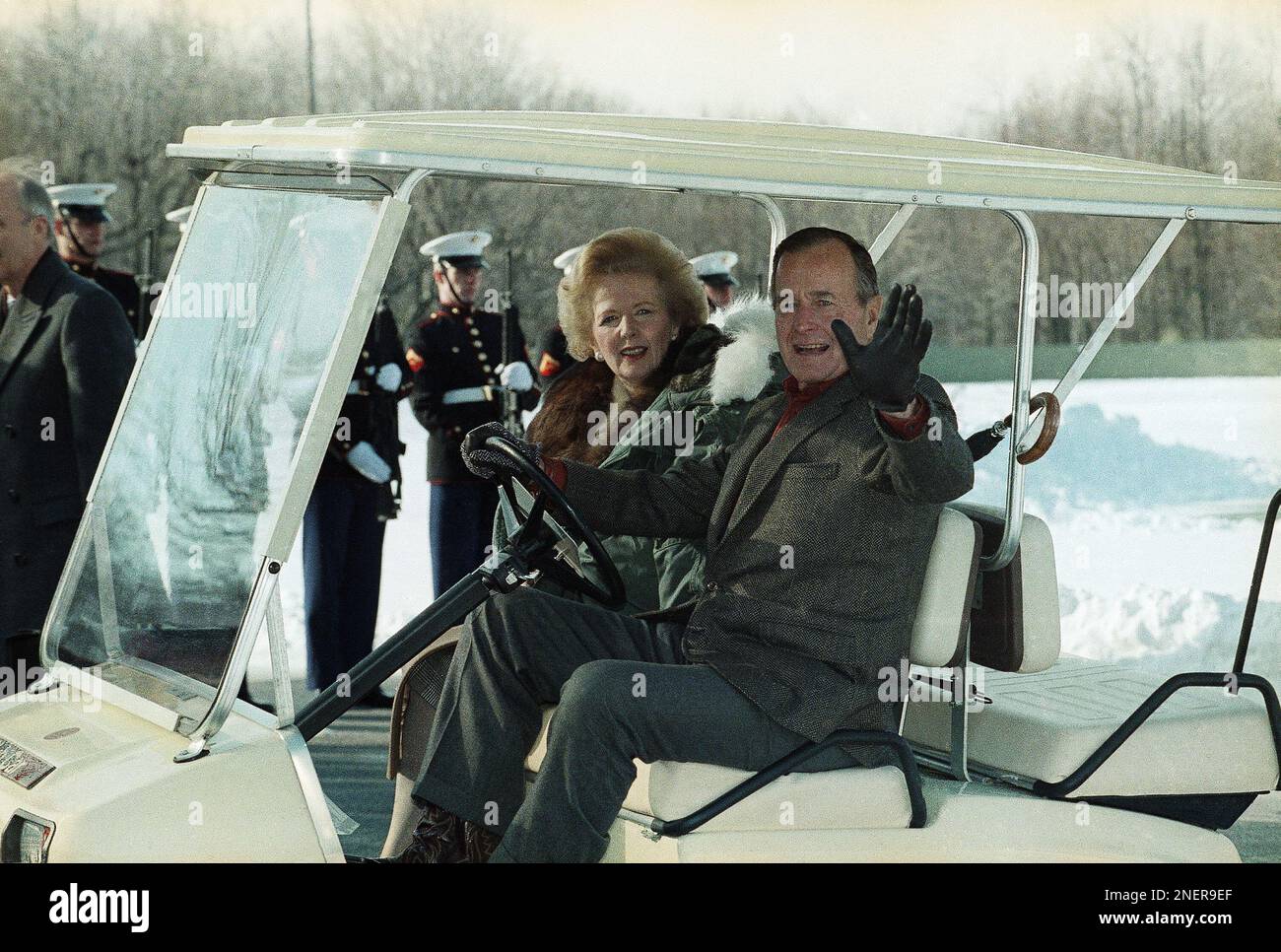 British Prime Minister Margaret Thatcher rides in a golf cart with ...