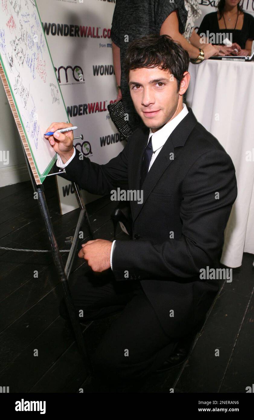 Actor Michael Rady signs the wonderwall.com poster backstage at the ...
