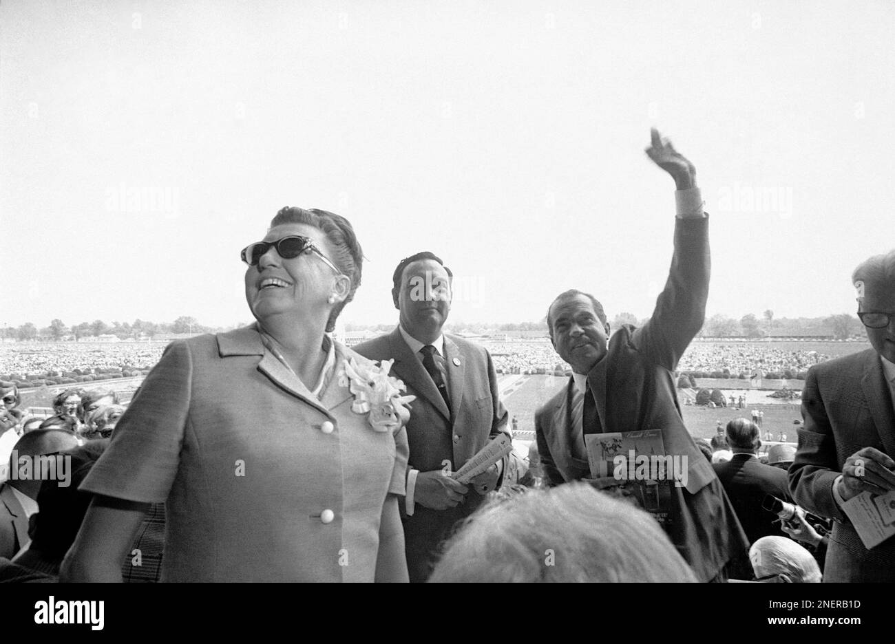 President Richard M. Nixon, clutching his program, turns to wave from ...